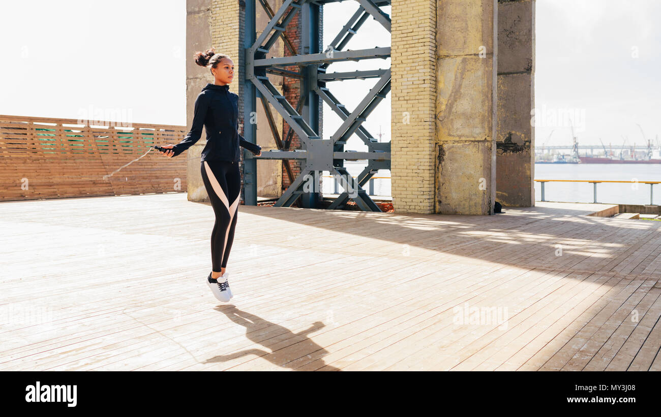 Female athlete skipping with jumping rope outdoors Stock Photo - Alamy