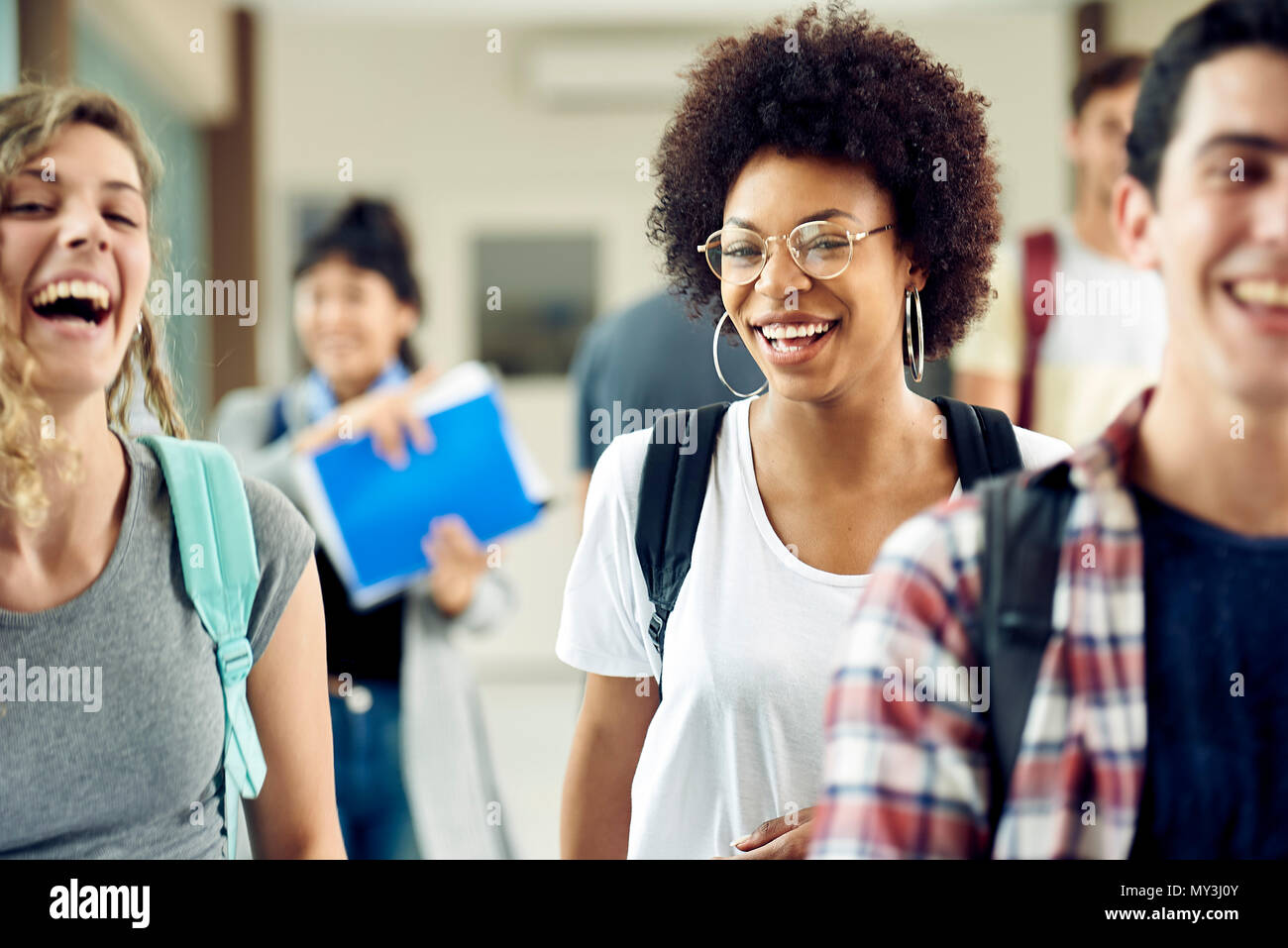 College students walking and laughing on campus Stock Photo - Alamy
