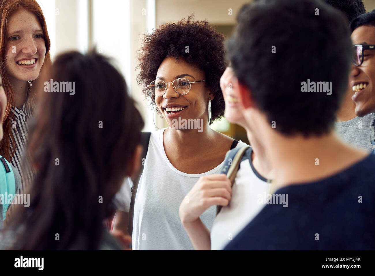 Students chatting together in school corridor Stock Photo - Alamy