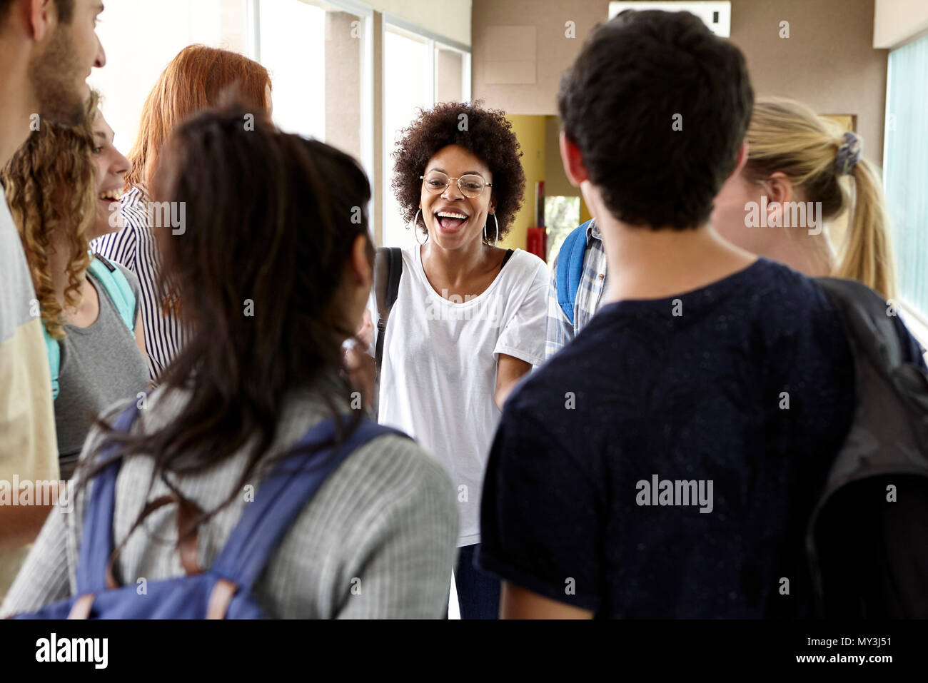 Students chatting together in school corridor Stock Photo - Alamy