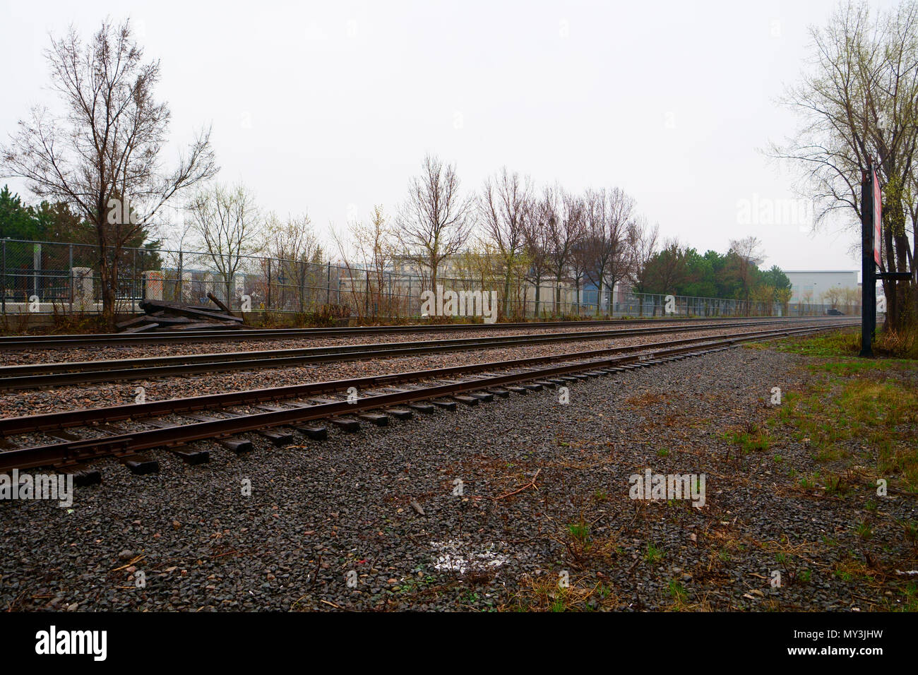 A three way rail road track in an urban environment, during the day ...