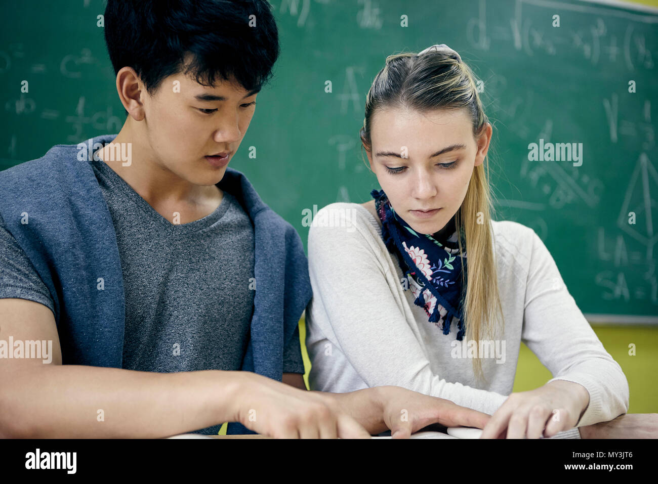 Students working together in in math class Stock Photo - Alamy
