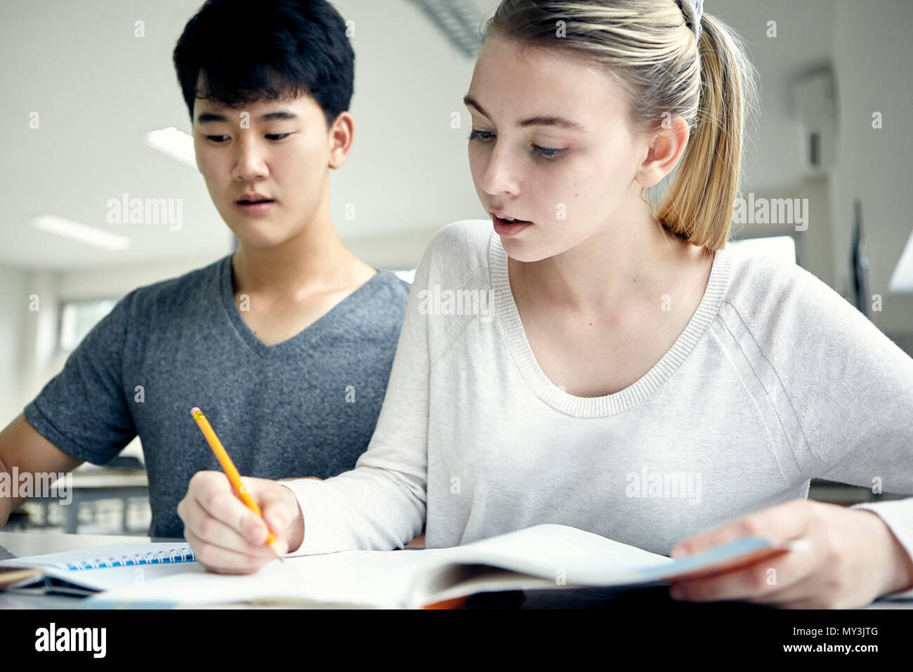 Two male students working together hi-res stock photography and images ...