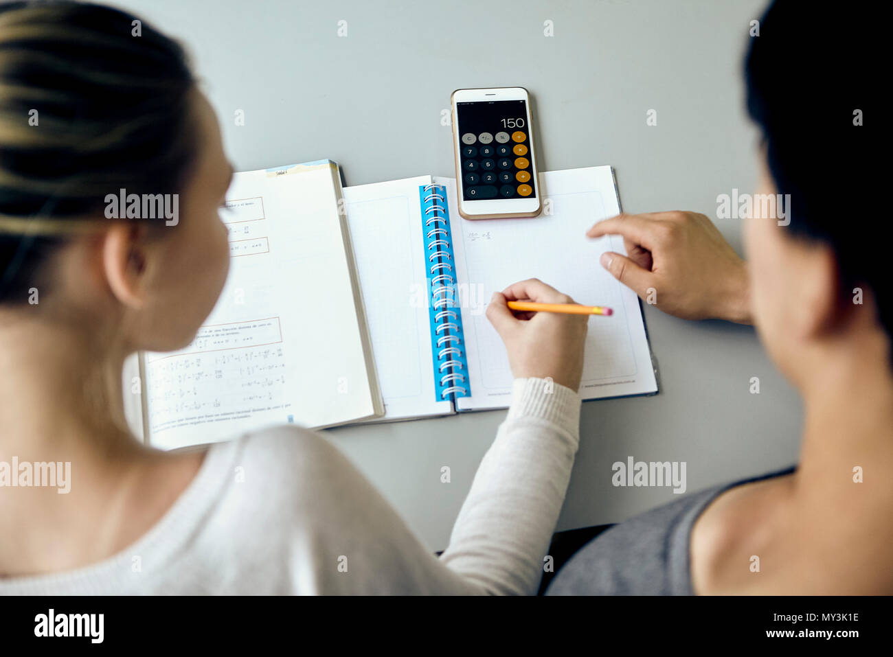 Students working together on mathematics assignment Stock Photo - Alamy