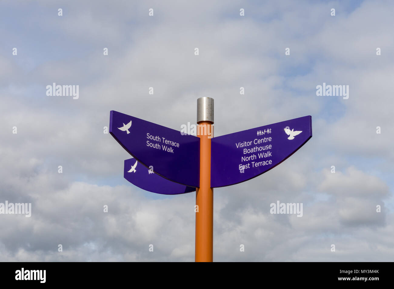 Three way wooden sign post giving directions for visitors to the ...