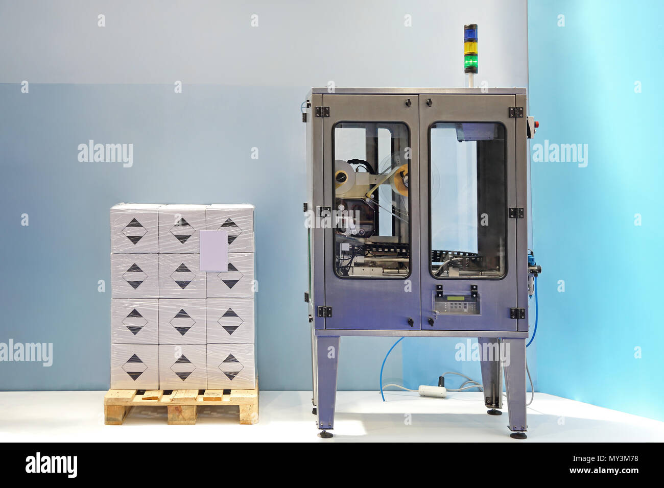 Automatic Labelling Machine and Boxes at Pallet Stock Photo - Alamy