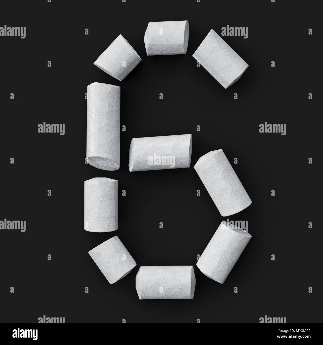 White blackboard chalks assembled like mathematical digit 6 on rough ...