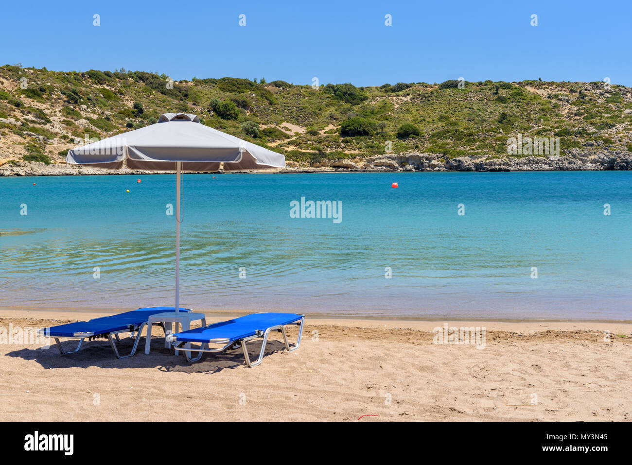 Sun loungers with umbrella on beautiful sandy Kolymbia beach. Rhodes ...