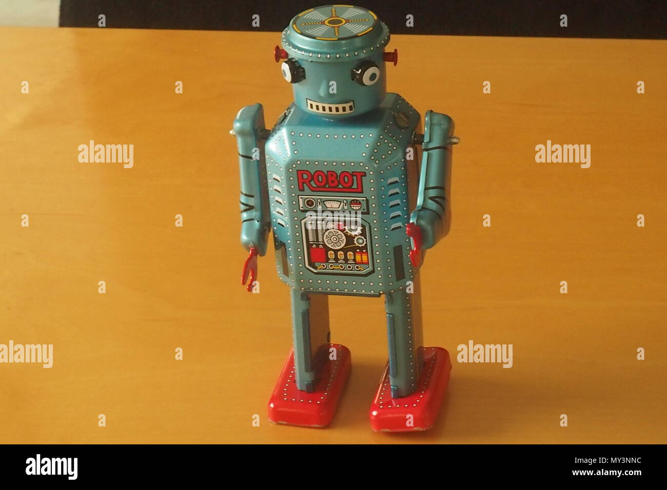 Tin toy robot, grey tray with red hands and feet Stock Photo - Alamy