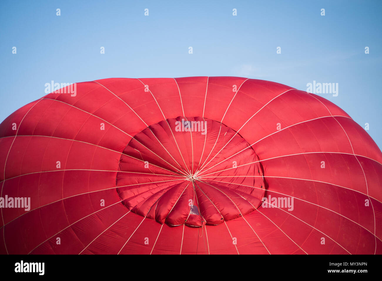 A hot air balloon canopy is slowly inflated prior to an evening ride ...