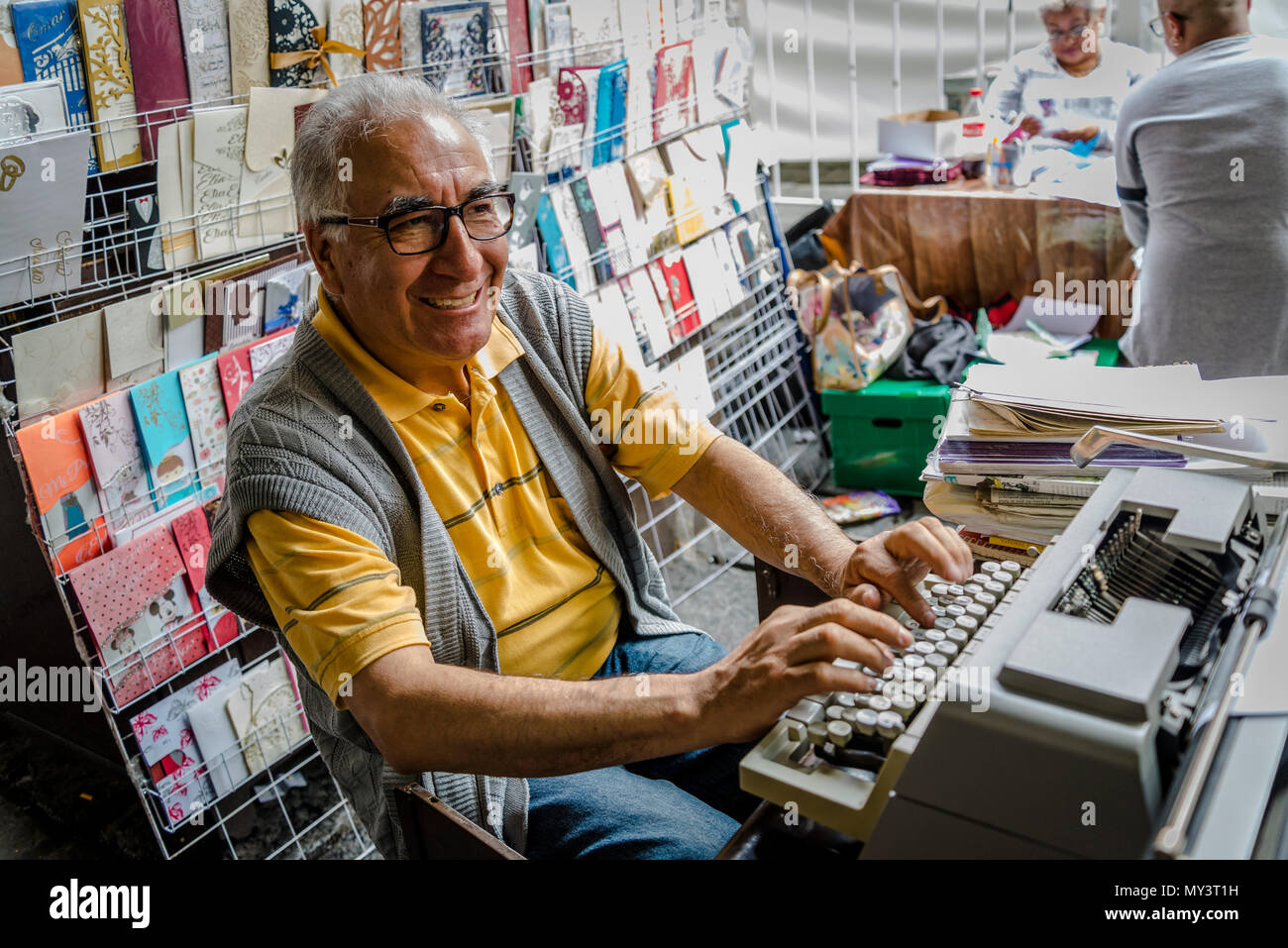 Clerk typing on electrical typewriter carrying on the ancient tradition ...