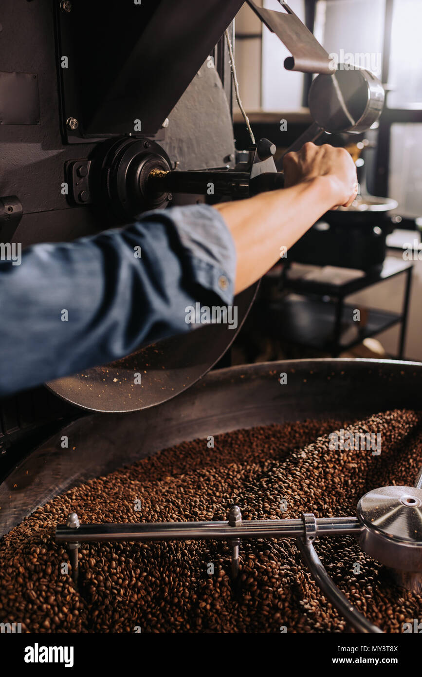 partial view of coffee roaster working on roasting machine Stock Photo ...