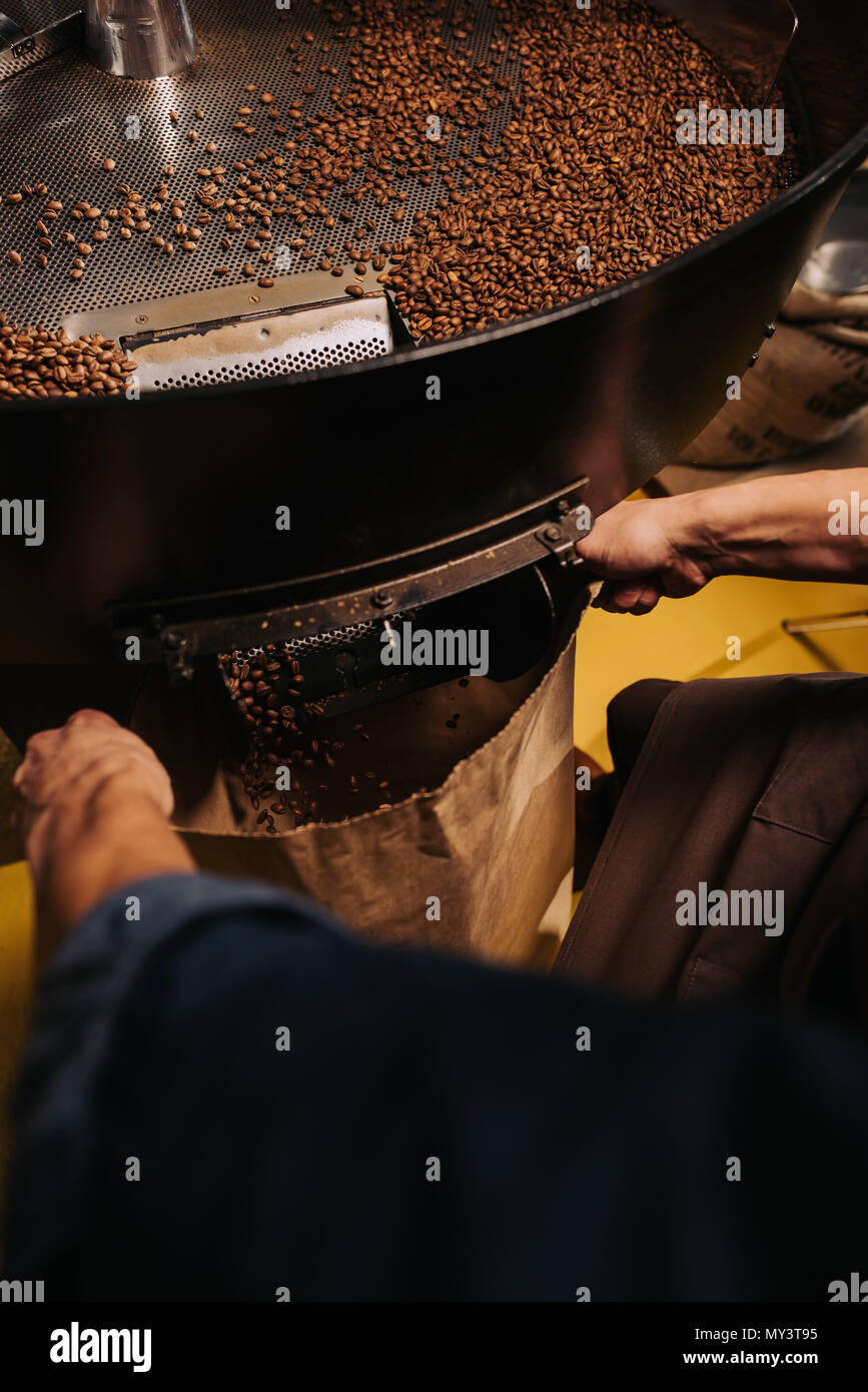 partial view of coffee roaster working on roasting machine Stock Photo ...