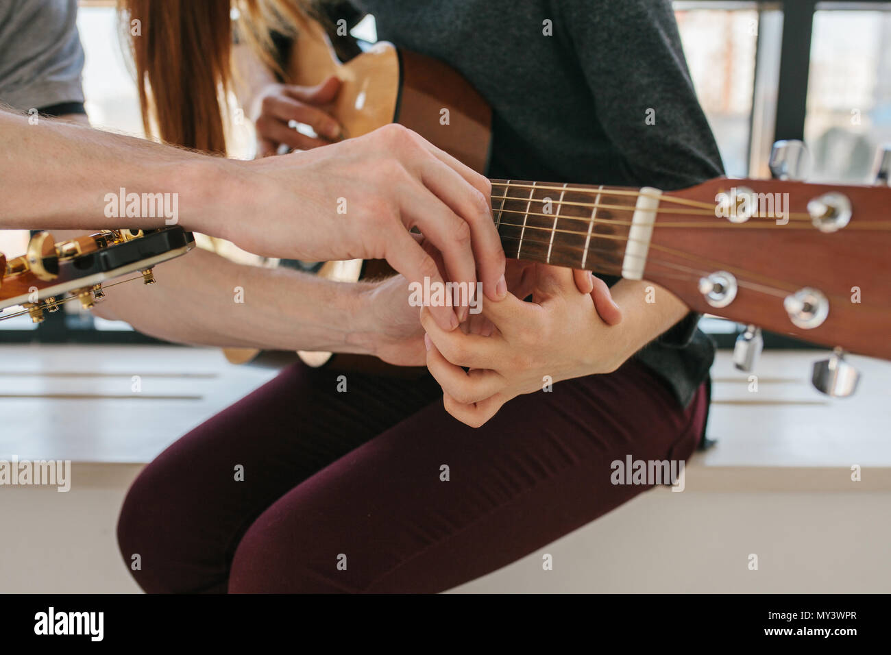 Man teaching woman play guitar hi-res stock photography and images - Alamy