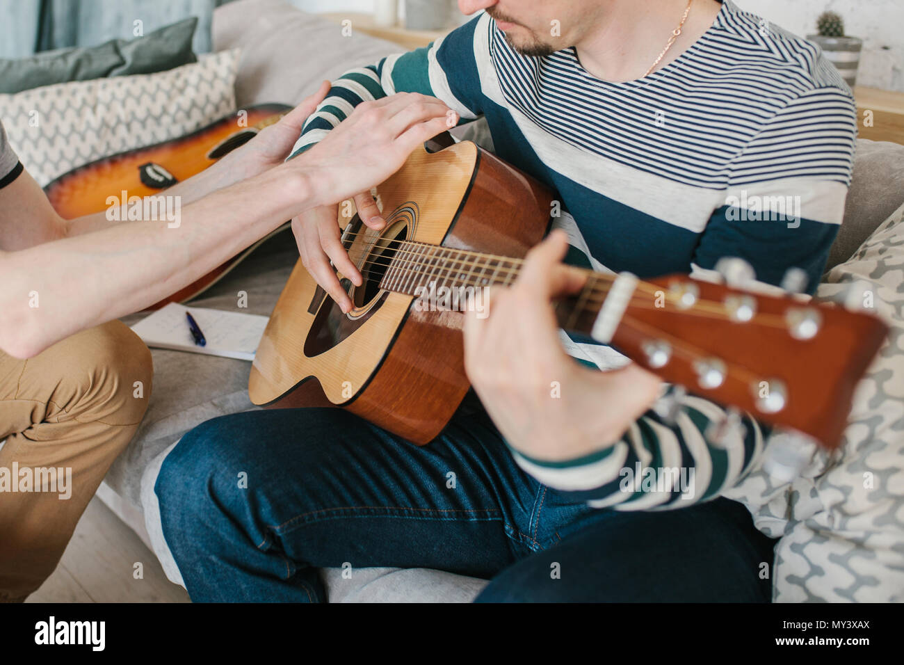 Learning to play the guitar. Music education Stock Photo - Alamy