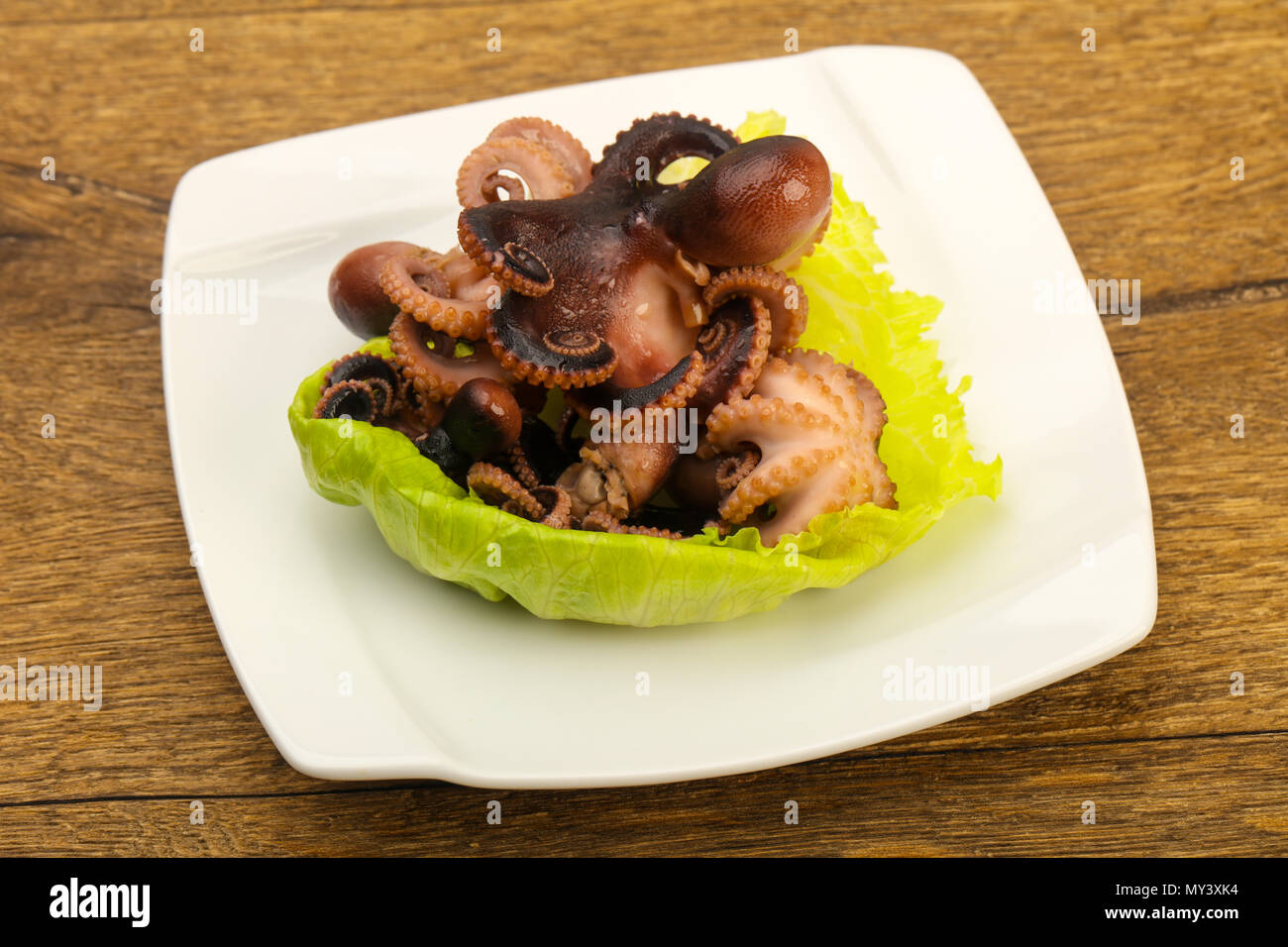 Boiled baby octopuses over salad leaves Stock Photo - Alamy