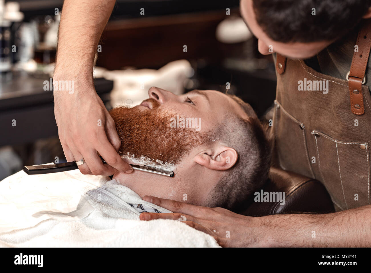 Barber and bearded man in barber shop Stock Photo - Alamy