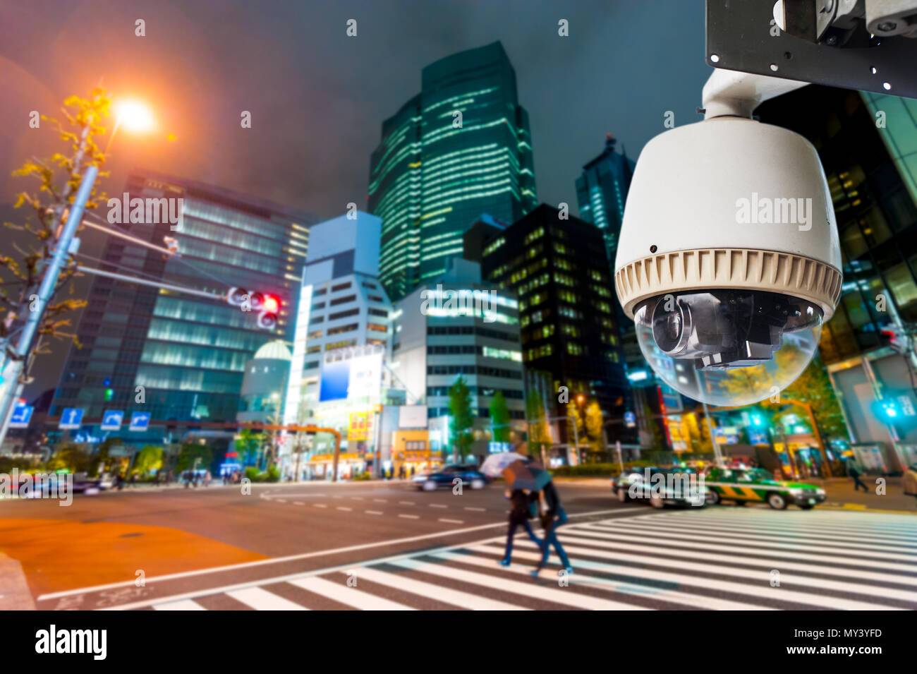 CCTV Camera or surveillance operating on street and building at night ...
