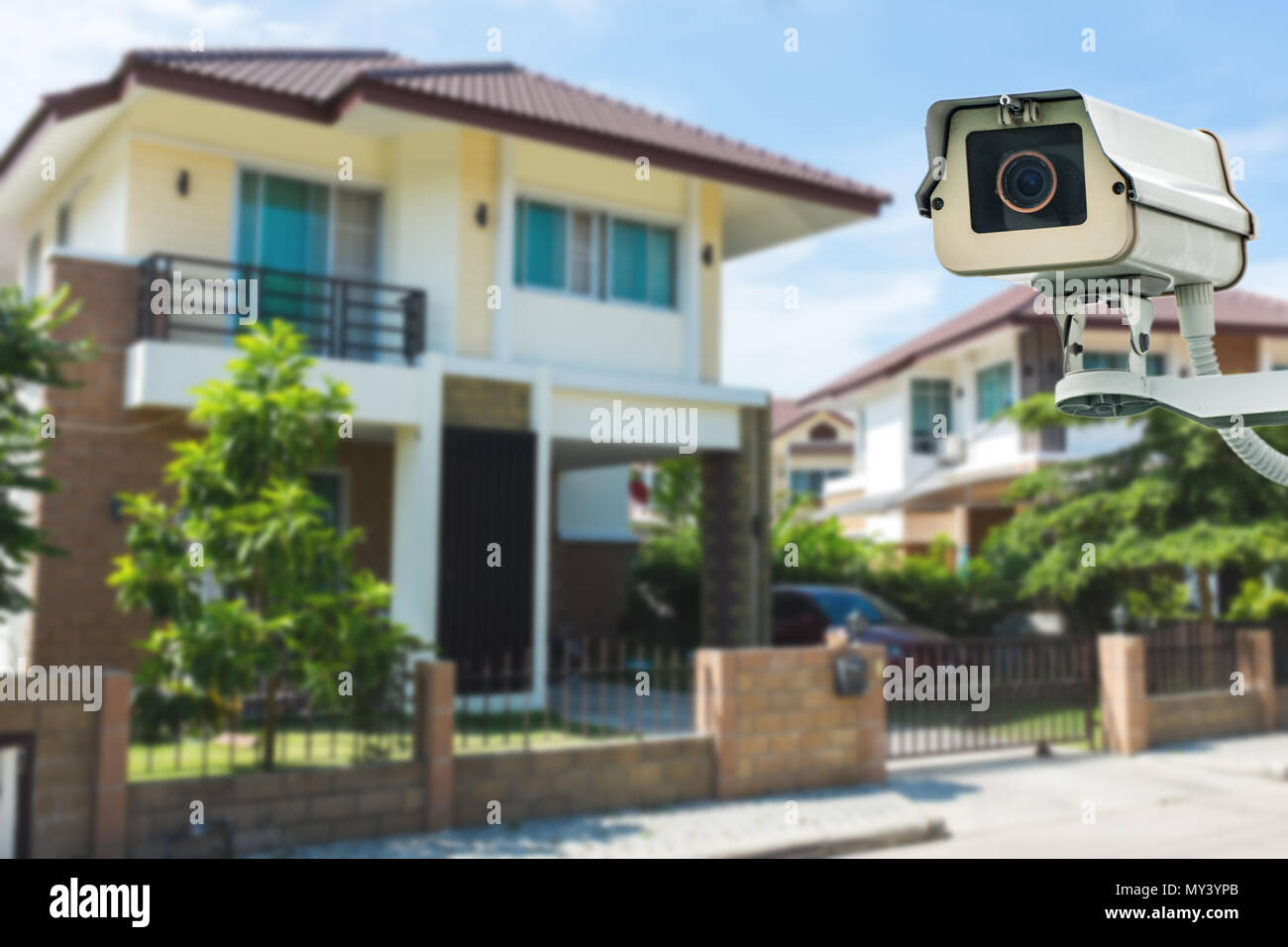 CCTV Camera with house and village in background Stock Photo - Alamy