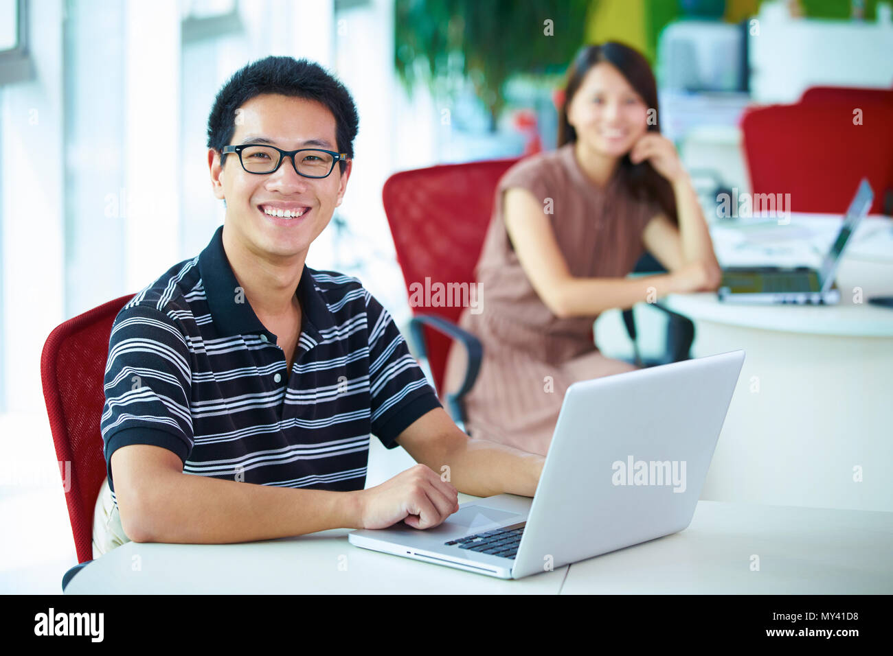 Young Asian business people in the Office Stock Photo - Alamy
