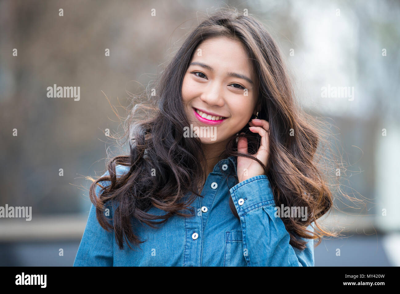 Picture of One beautiful young Chinese woman using mobile phone outdoor ...
