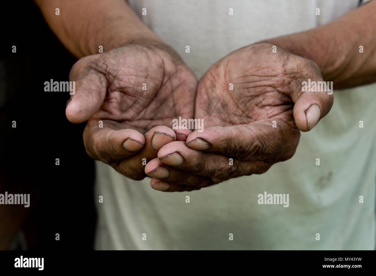 The poor old man's hands beg you for help. The concept of hunger or ...