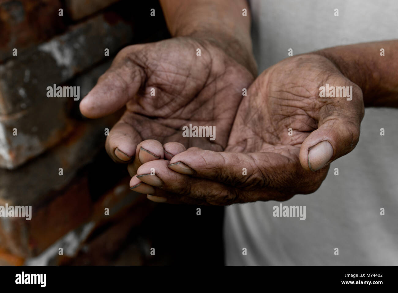The poor old man's hands beg you for help. The concept of hunger or ...