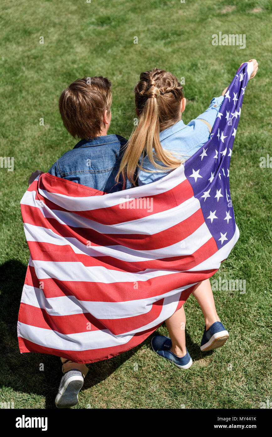 adorable siblings with american flag having fun outdoors, America's ...