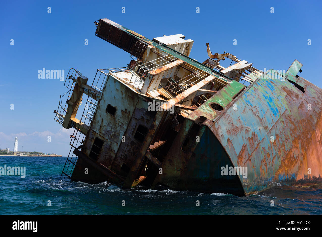 The hull of the wrecked ship in the blue sea on the background Stock ...
