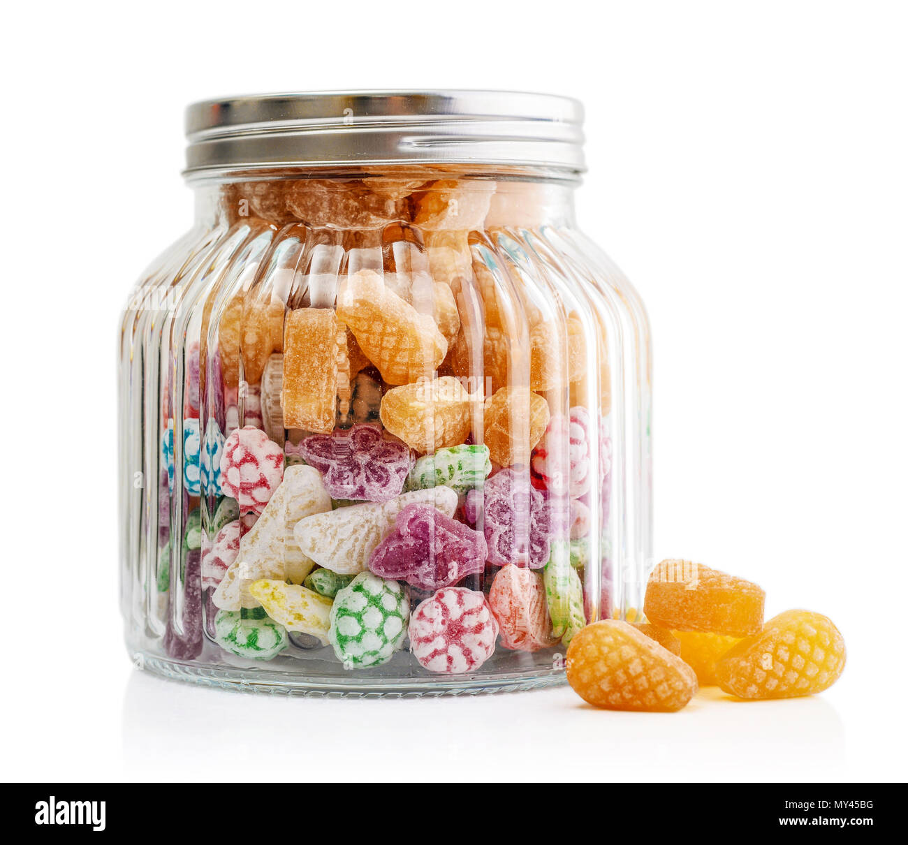 Mixed colorful fruit bonbon in transparent jar isolated on white ...