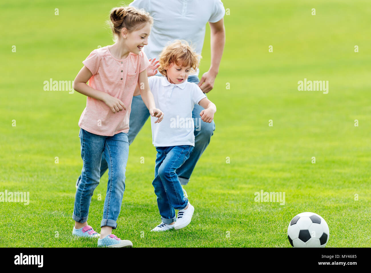 Family kids play soccer together hi-res stock photography and images ...