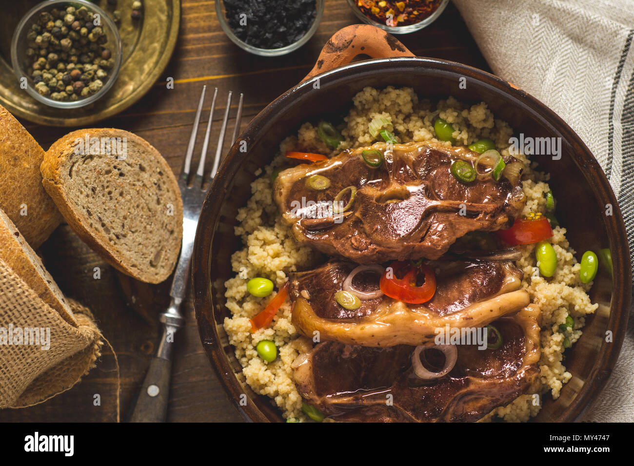 Roasted Lamb Loin Chops with Couscous and Soybean in Rustic Clay Dish ...