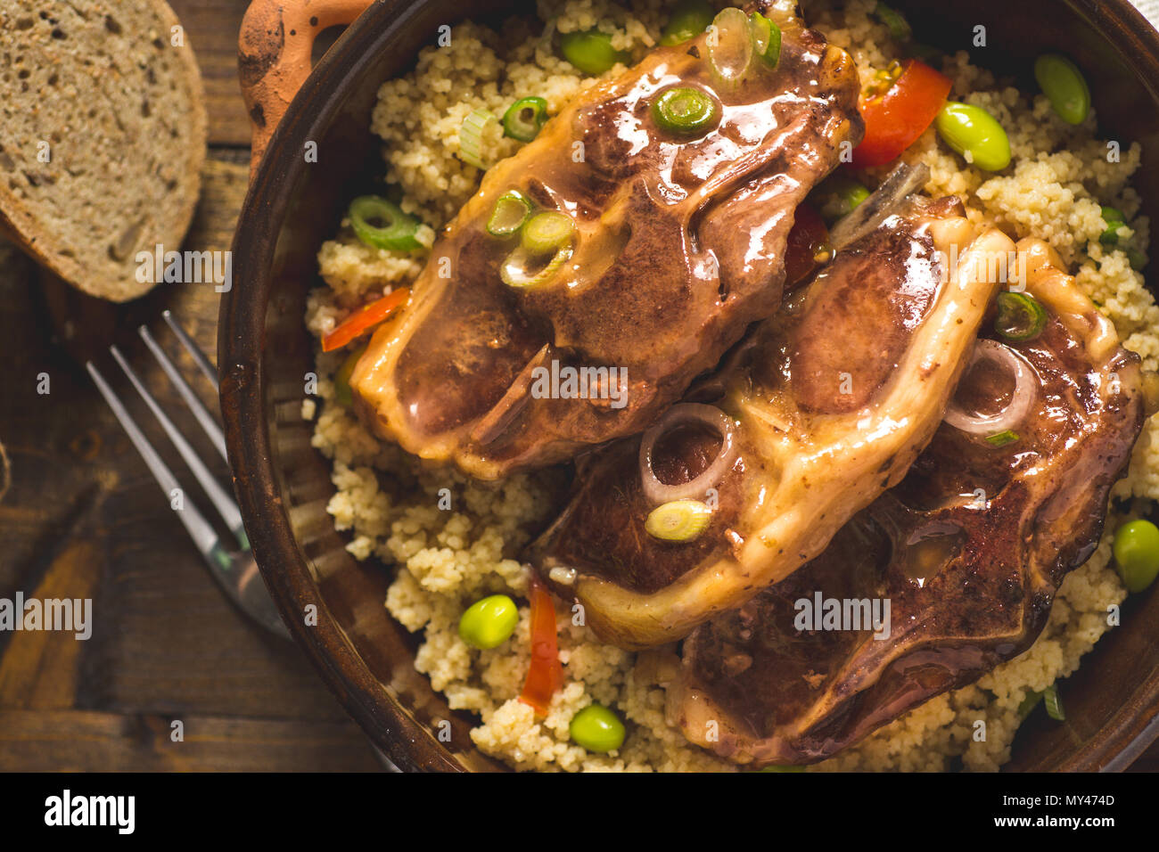 Roasted Lamb Loin Chops with Couscous and Soybean in Rustic Clay Dish ...