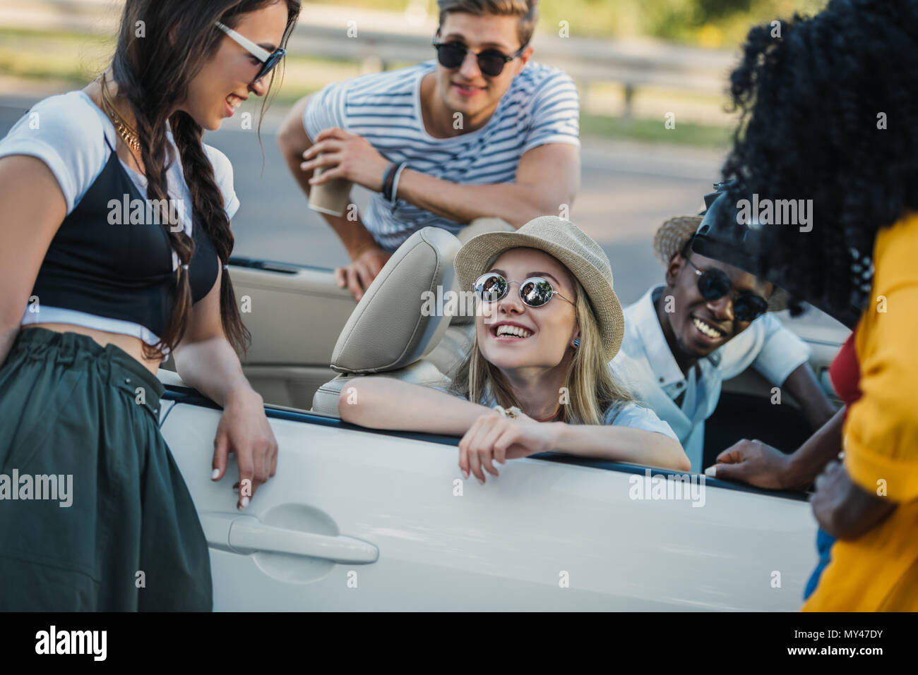 multiethnic group of happy friends having conversation together Stock ...