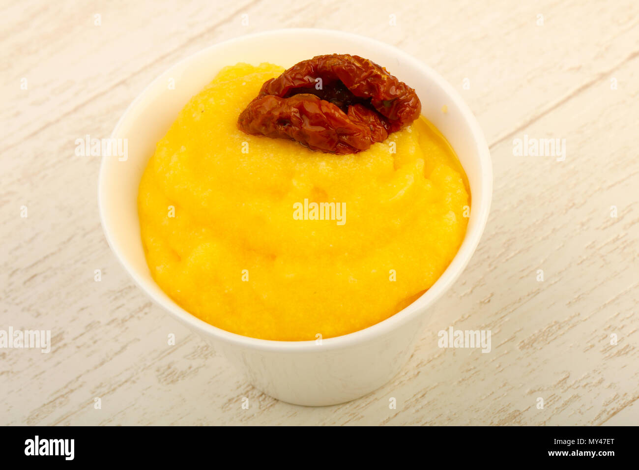Polenta with dry tomato Stock Photo - Alamy