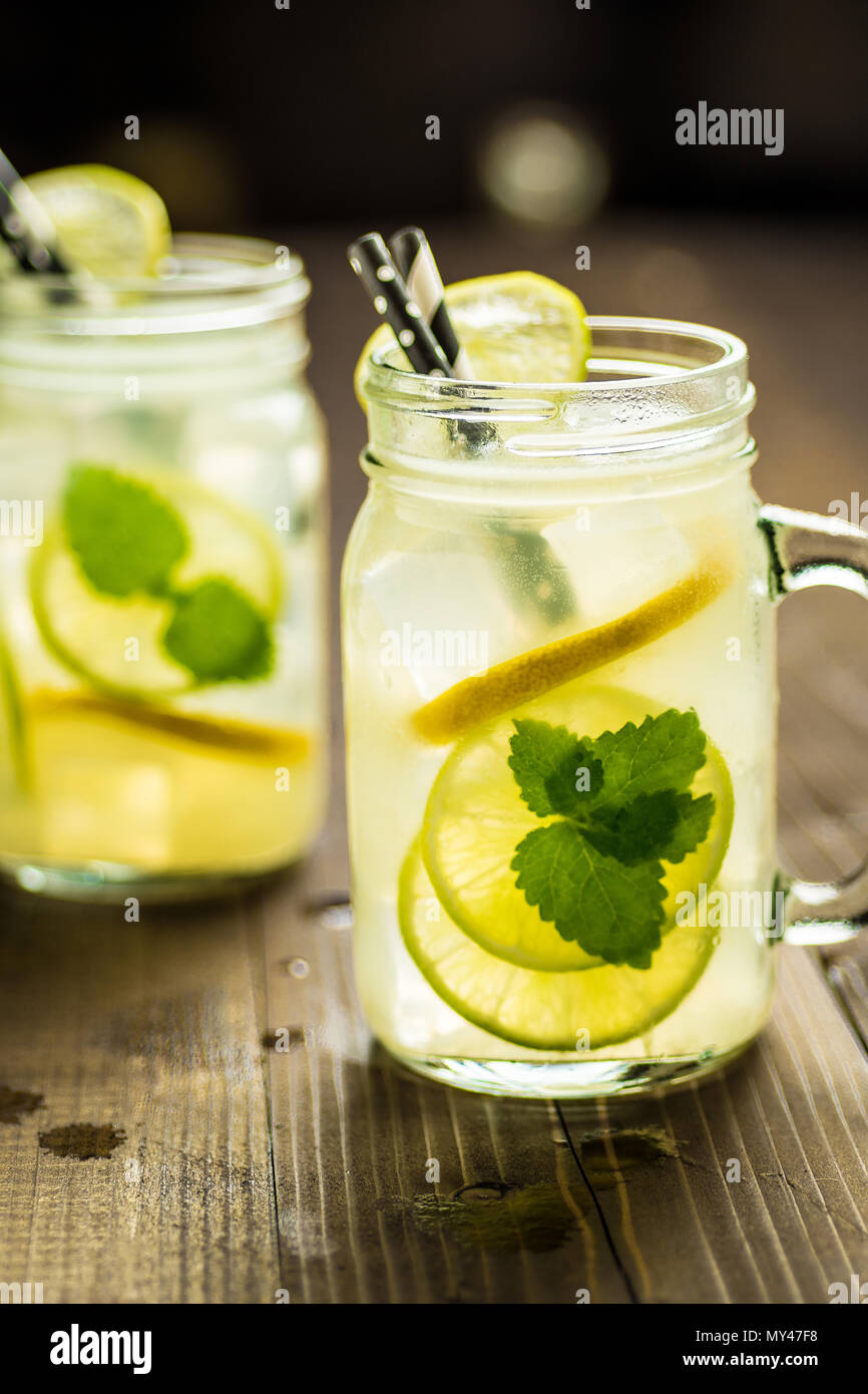 Cold Fresh Lemonade Mojito Cocktail with Ice, Lemon and Mint Leaves in ...