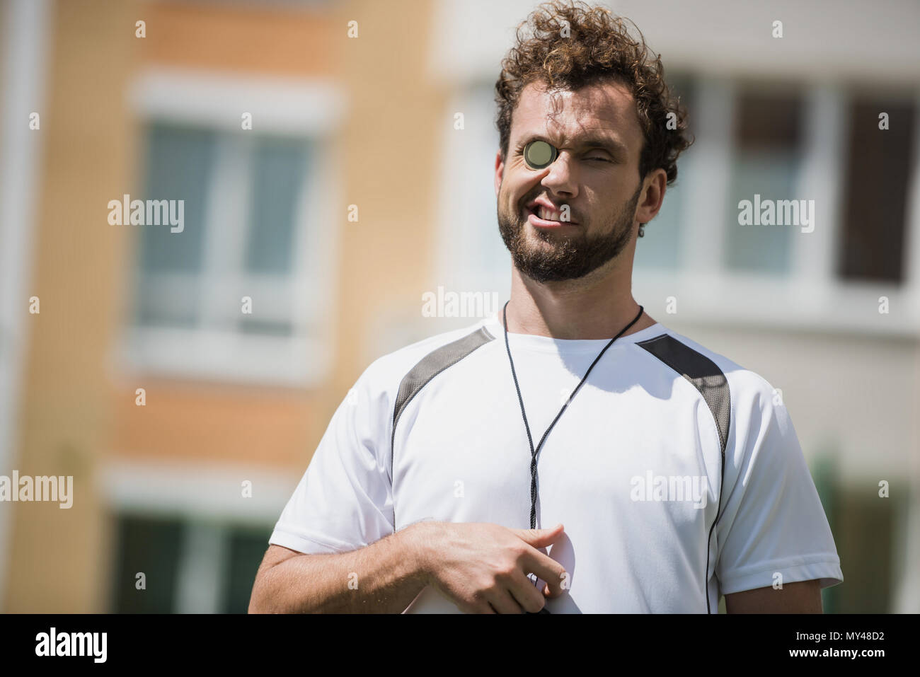 portrait of young grimace soccer referee with coin on eye Stock Photo ...