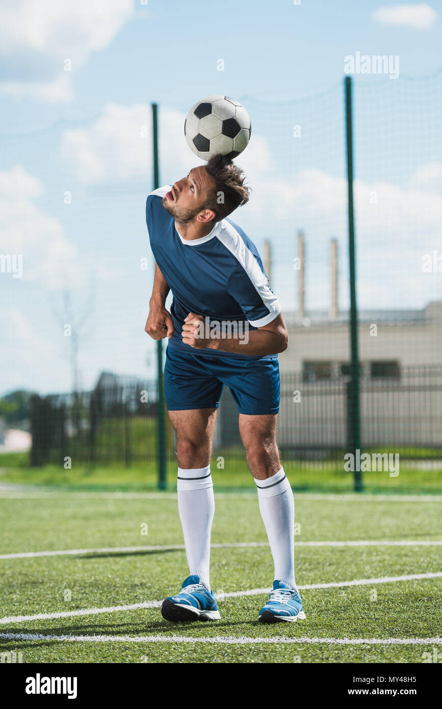 focused soccer player training with ball on soccer pitch Stock Photo ...