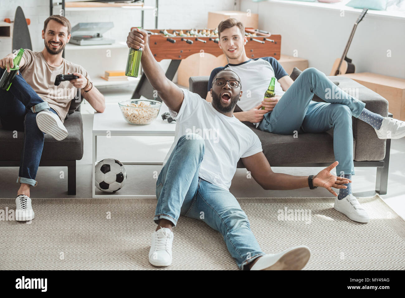 Celebrating football living room hi-res stock photography and images ...