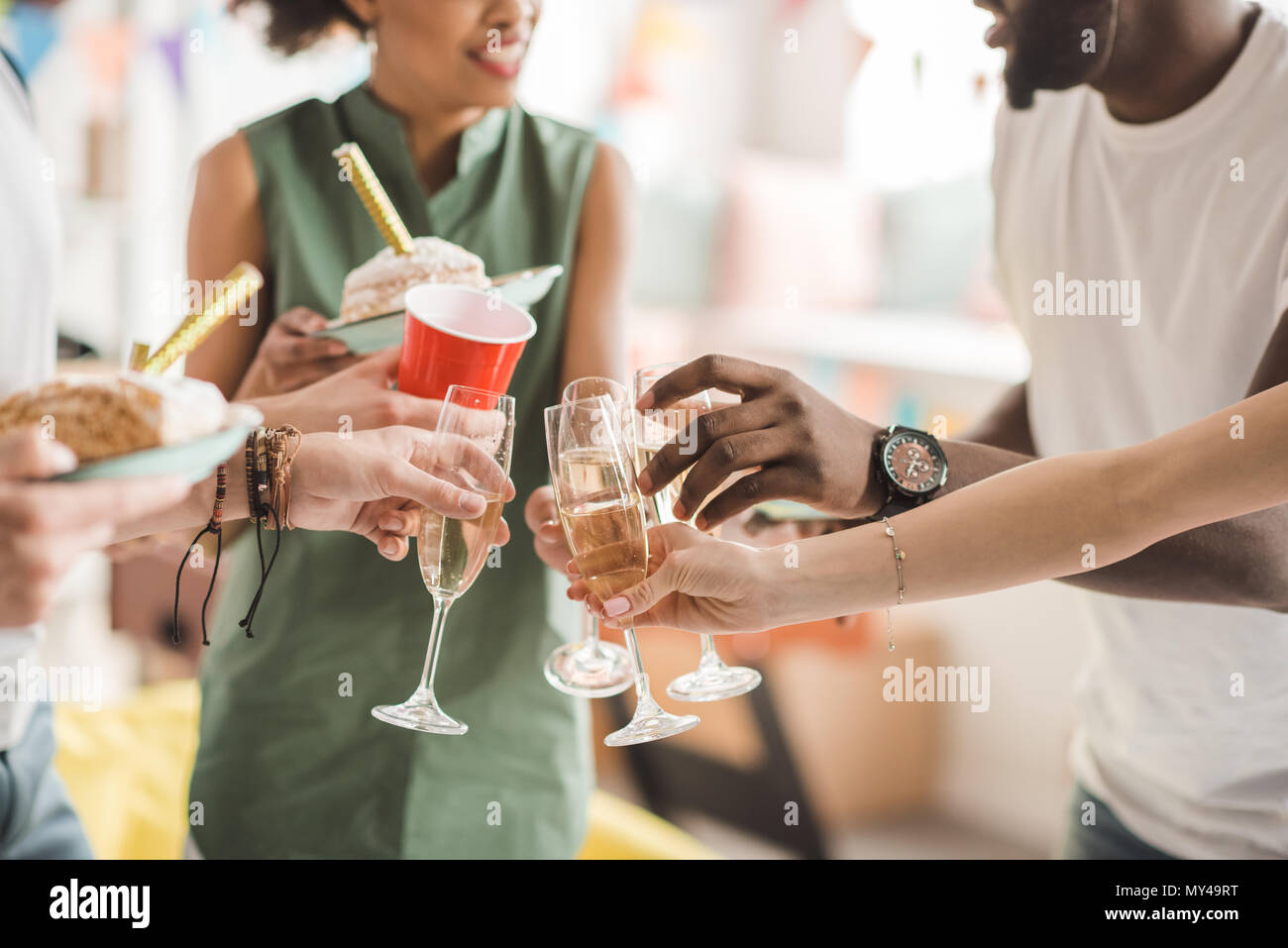 Young men and women toasting with champagne at birthday party Stock ...