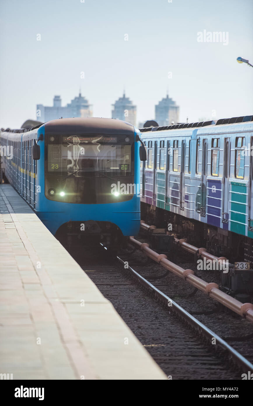 trains at outdoor subway station with buildings on background Stock ...