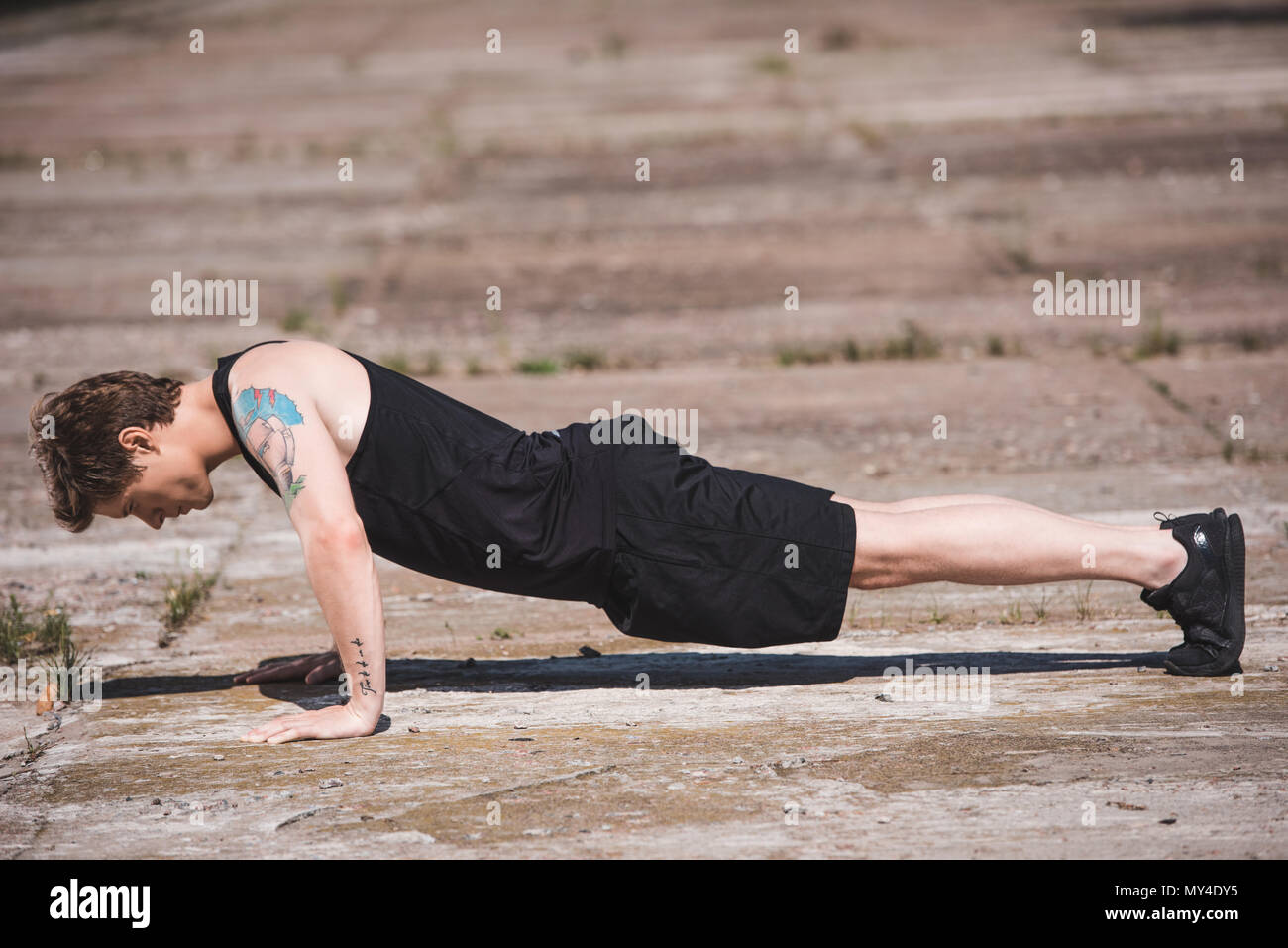 side view of athletic man doing push ups exercise on slabs Stock Photo ...