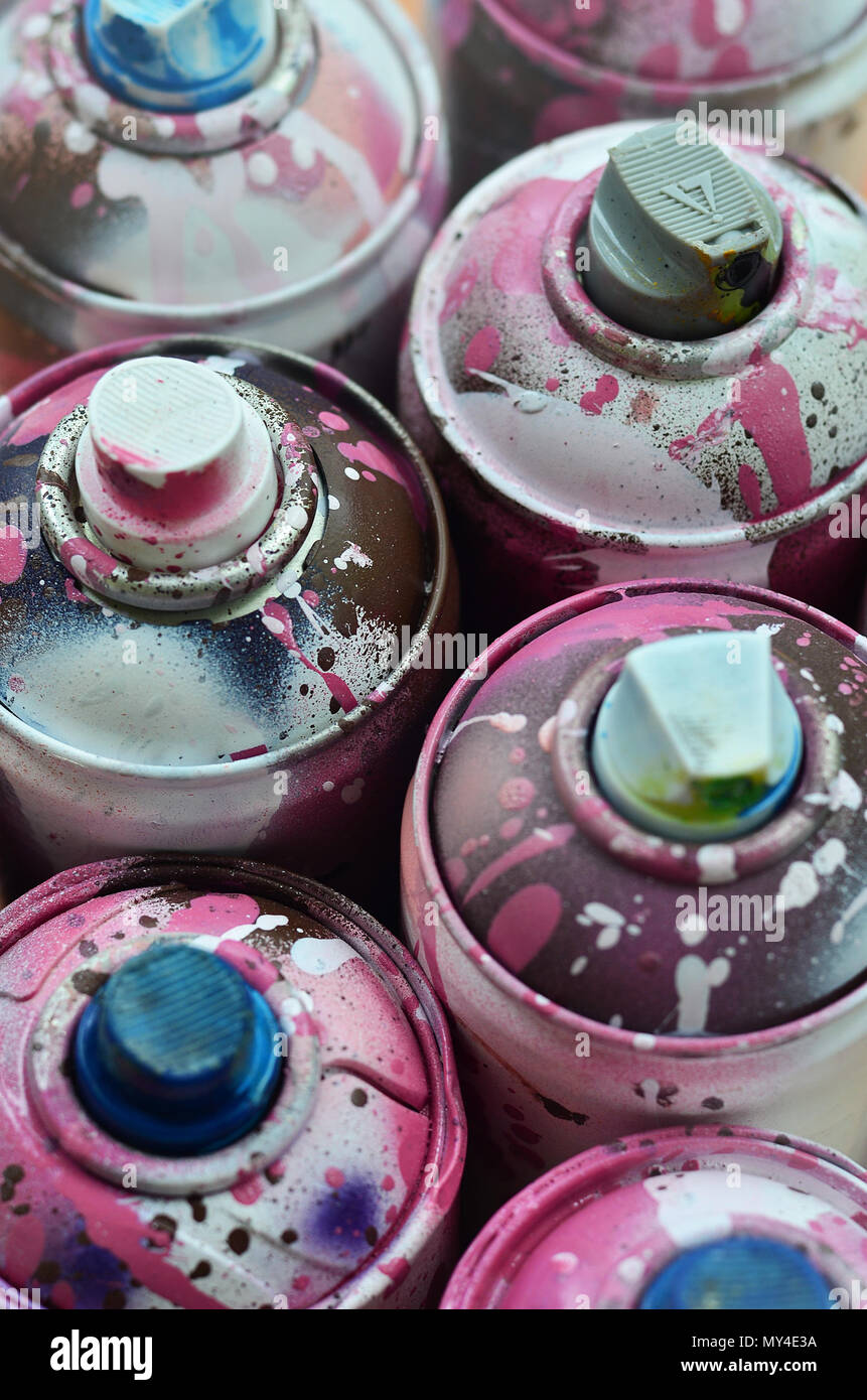 A lot of used spray cans of paint close-up. Dirty and smeared cans for ...