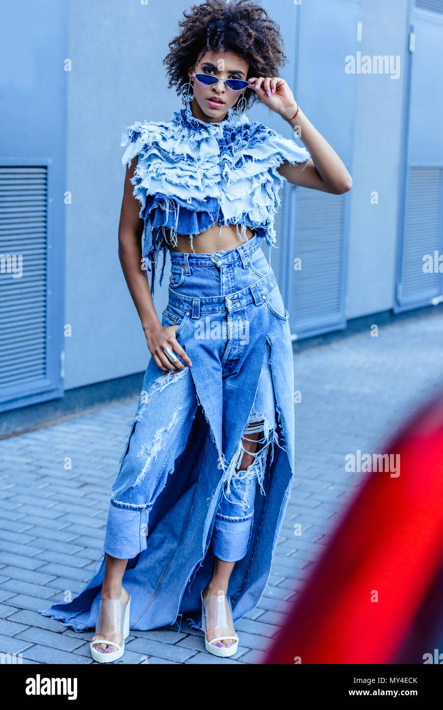 stylish afro girl in denim clothes and sunglasses posing for fashion ...