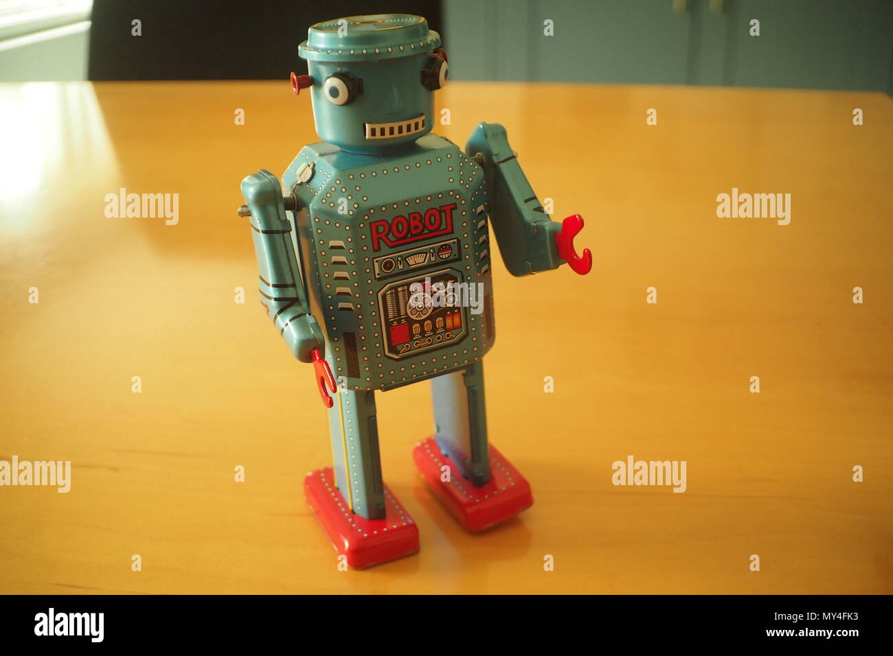 Tin toy robot, grey tray with red hands and feet Stock Photo - Alamy