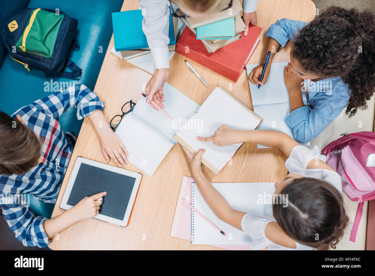 top view of teacher and pupils doing homework together Stock Photo - Alamy