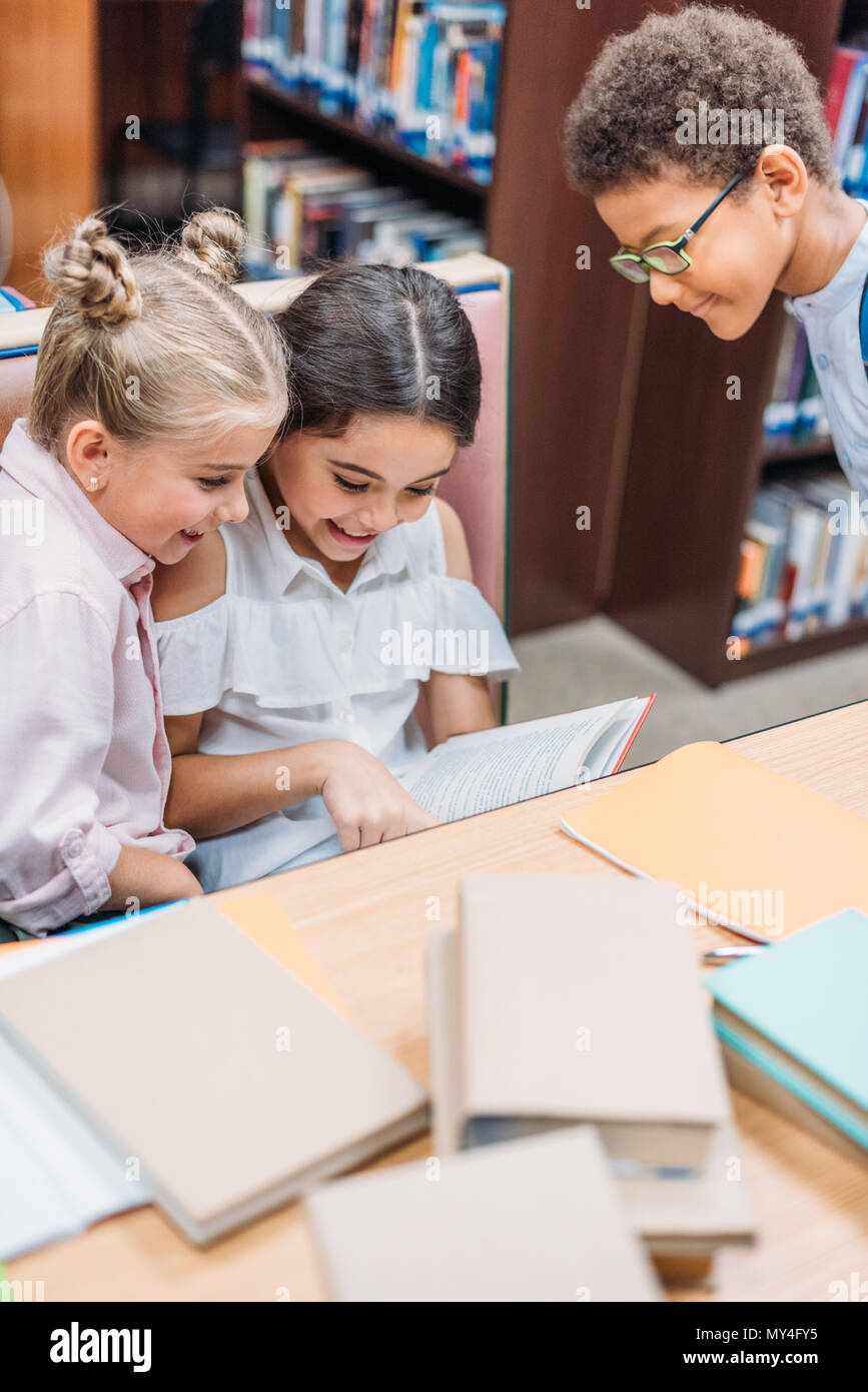 funny little kids reading book in library Stock Photo - Alamy