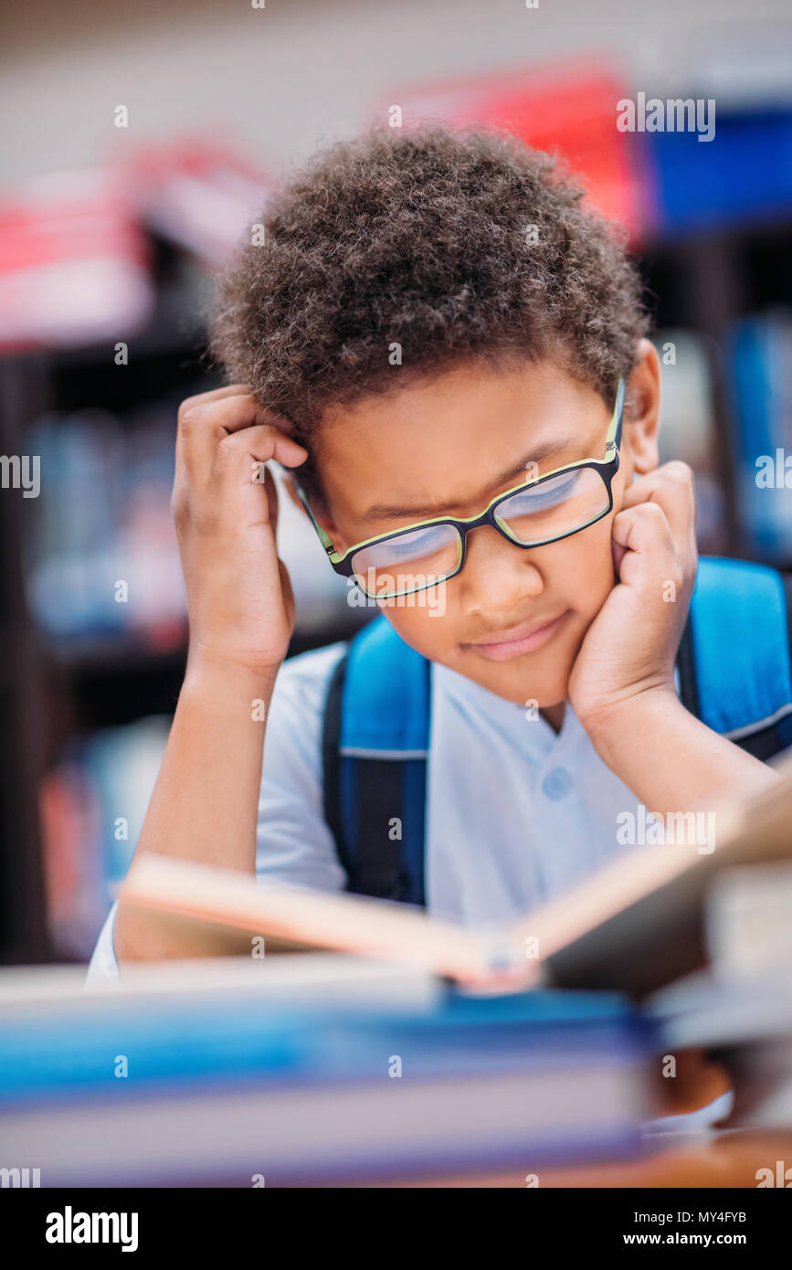 Black boy reading book library hi-res stock photography and images - Alamy