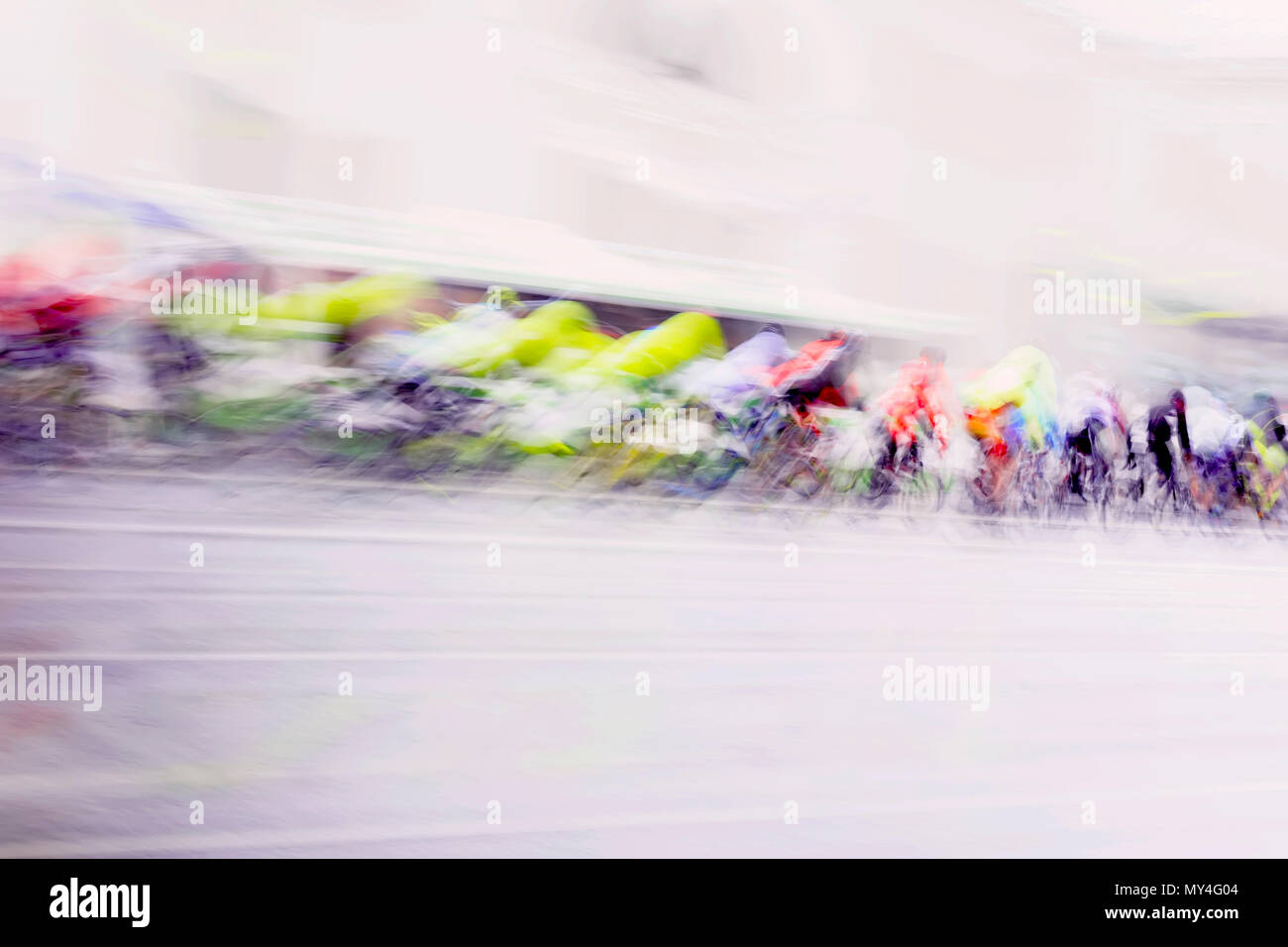 Silhouettes of group colorful racing cyclists on the city roadway, day ...