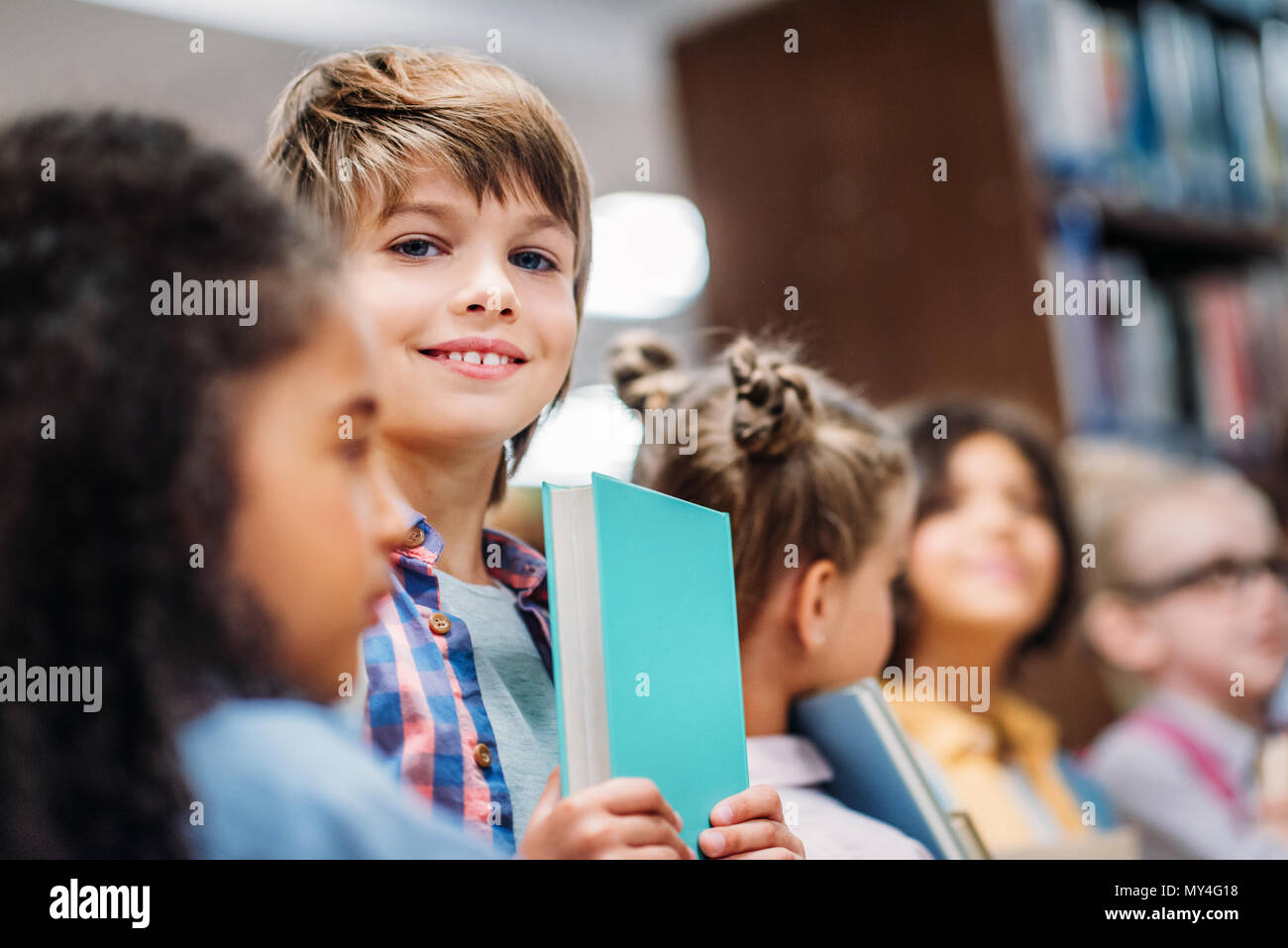 adorable little kids with books in school library Stock Photo - Alamy